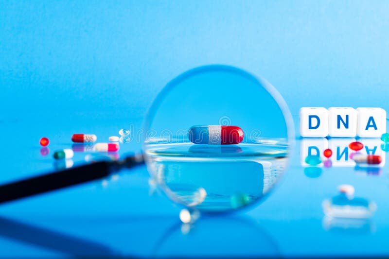 DNA Pill on the Background of a Laboratory Table with Medicines and ...