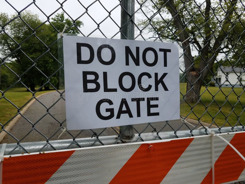 Do Not Block Gate Sign on Metal Chain Link Fence with Street Stock ...