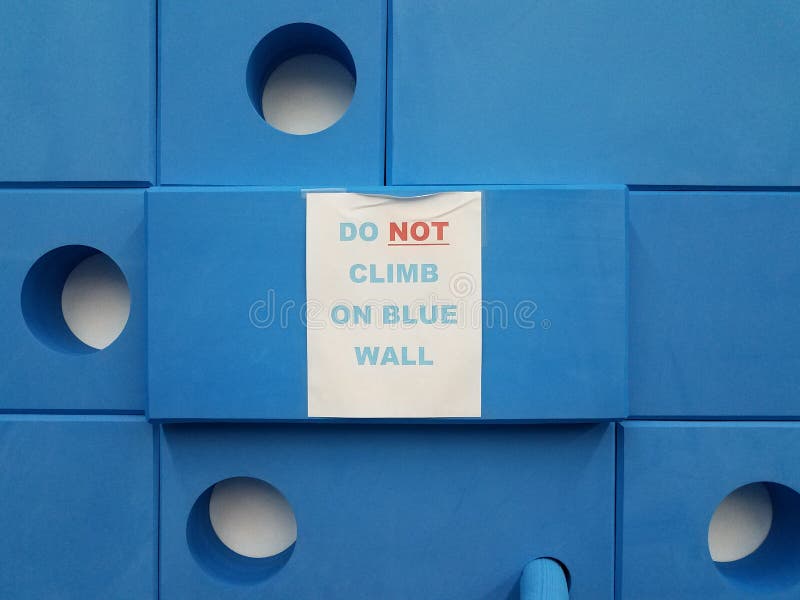 Do Not Climb on Blue Wall Sign and Foam Blocks Stock Image - Image of ...