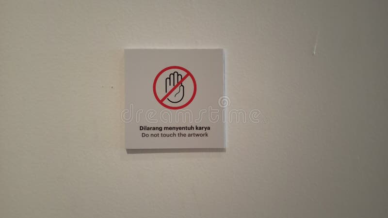 Do Not Touch Signage on a White Wall Stock Photo - Image of signage ...
