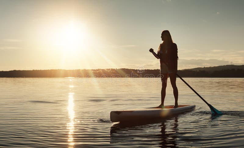 Do Whatever Floats Your Boat An Attractive Young Woman Paddle Boarding On A Lake Stock Image
