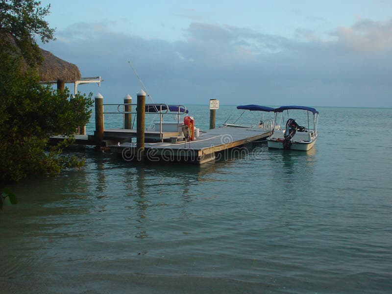 Dock stock photo. Image of island, boats, boat, clouds - 139484