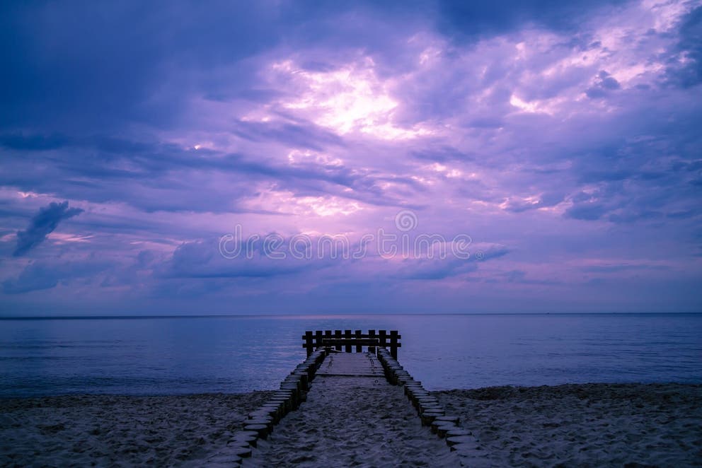 Dock on the Beach during the Purple Sunset Stock Image - Image of ...