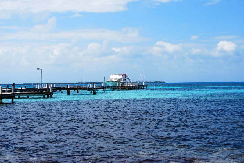Dock with a Boat in the Ocean Stock Image - Image of coast, beach: 62939095