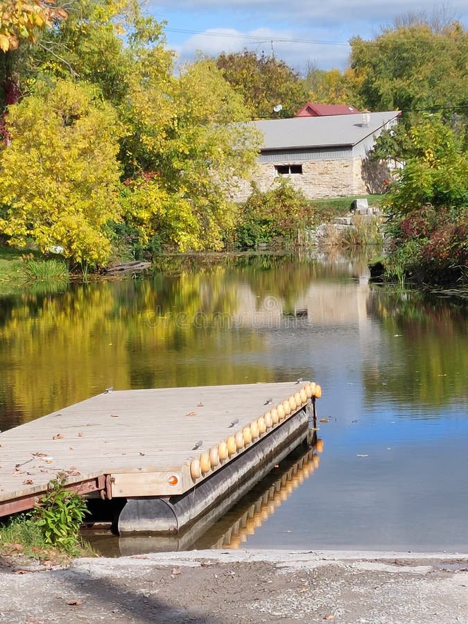 Dock on River with Stone Building in Background Stock Photo - Image of ...