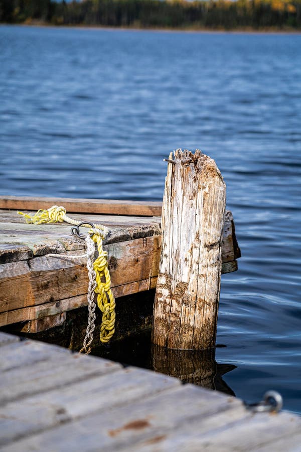 A Dock with a Wooden Post and a Yellow Chain Stock Image - Image of ...