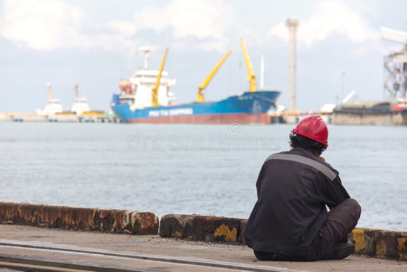 Dock Worker Finishing Work Sitting at the Port Stock Photo - Image of ...