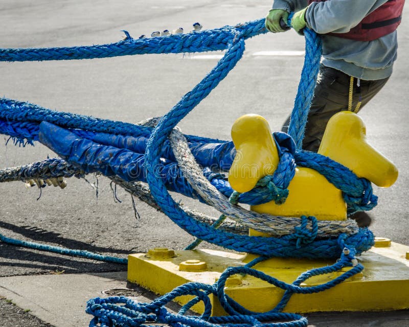 Dock Worker Pulling on Ropes Stock Image - Image of marine, marina ...