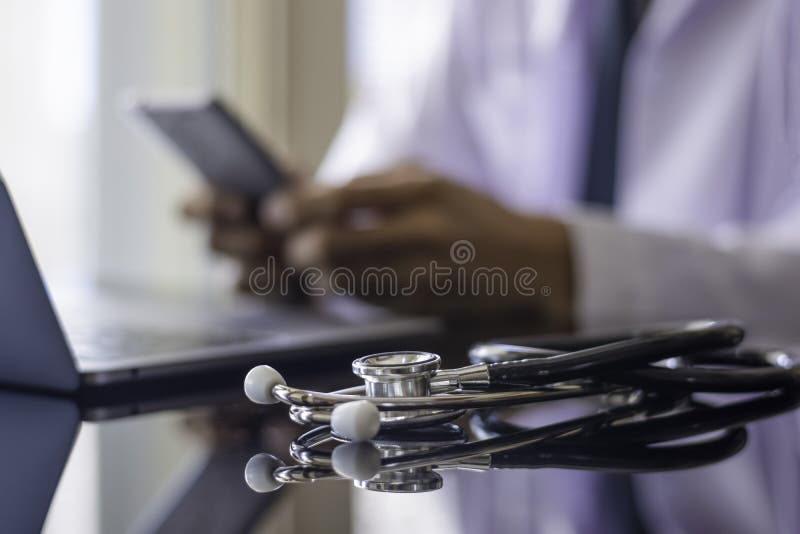 Doctor Using Mobile Smart Phone with Laptop Computer Stock Image ...