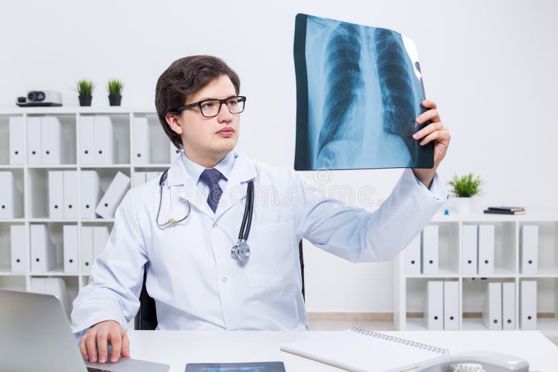 Doctor analyzing x-ray stock photo. Image of medicine - 70689270