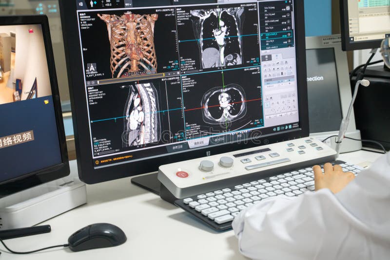 Doctor Analyzing the Test Results from MRI Scanner on the Computer ...