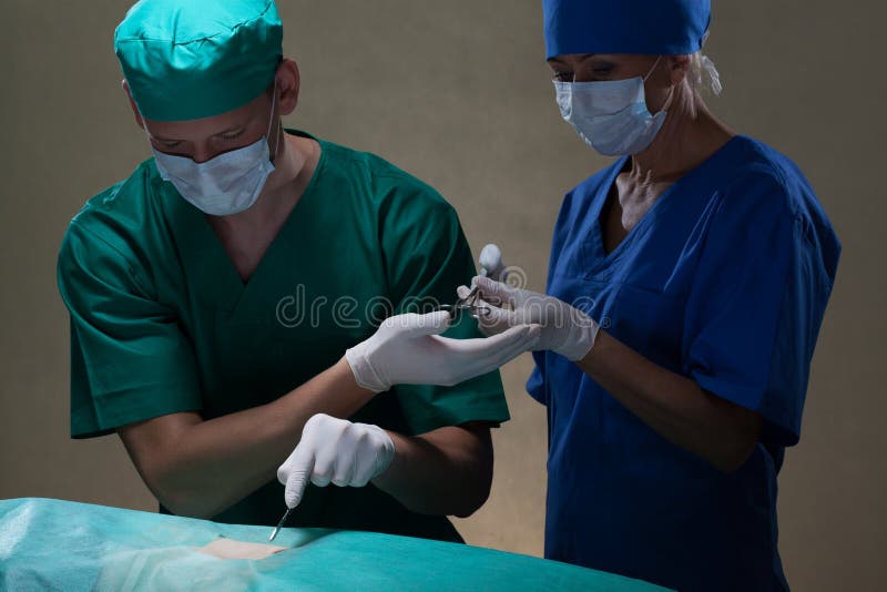 Doctor and Assistant during Surgery Stock Photo - Image of illness ...