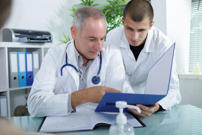 Doctor and Assistant Working Together at Hospital Stock Photo - Image ...