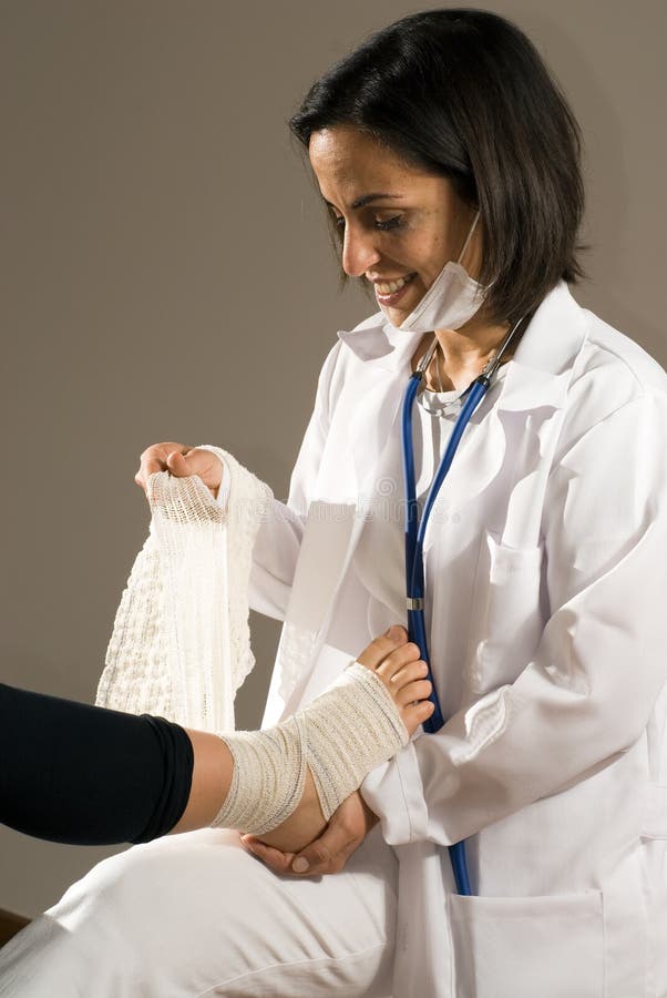 Doctor Bandages a Person S Foot-Vertical Stock Photo - Image of group ...