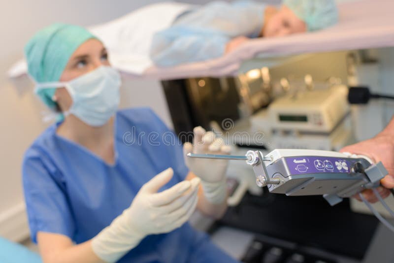 Doctor Being Passed Electrical Device Stock Image - Image of electrical ...