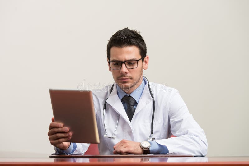 Doctor on a Break with His Computer Stock Image - Image of attractive ...