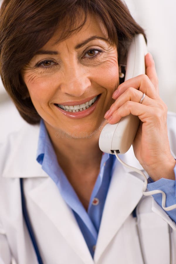 Doctor calling on phone stock image. Image of computer - 8377815