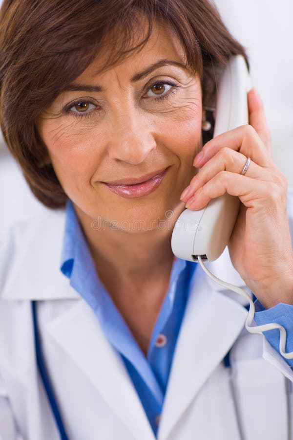 Doctor calling on phone stock image. Image of computer - 8377815