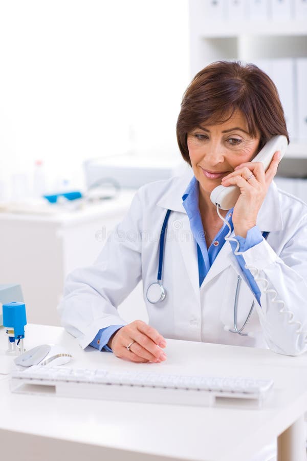 Doctor calling on phone stock image. Image of computer - 8377815