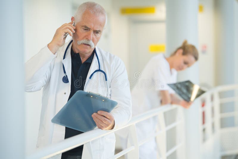 Doctor calling on phone stock photo. Image of treatment - 94037376