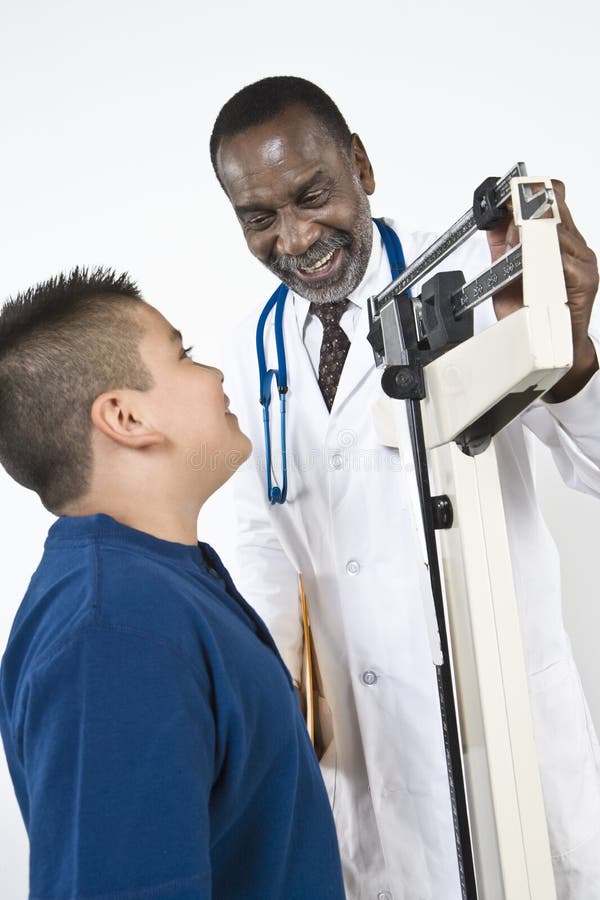 Doctor Checking Boy S Weight Stock Photo - Image of hispanic, boomer ...