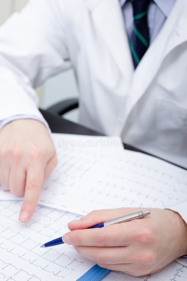Doctor Checking an Electrocardiogram Papers Stock Photo - Image of ...
