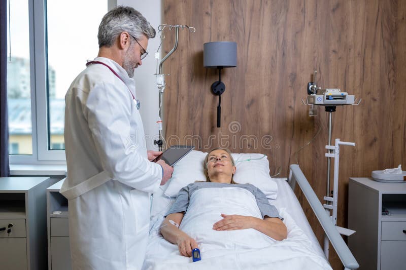 Doctor Checking a IV Drip in an Intensive Therapy Department and ...