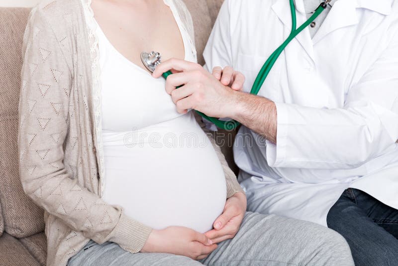 Doctor Is Checking Pregnant Woman`s Belly With A Stethoscope Physician