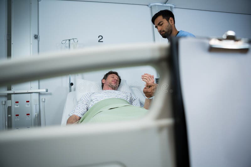 Doctor Checking Pulse of Patient Stock Photo - Image of physician ...