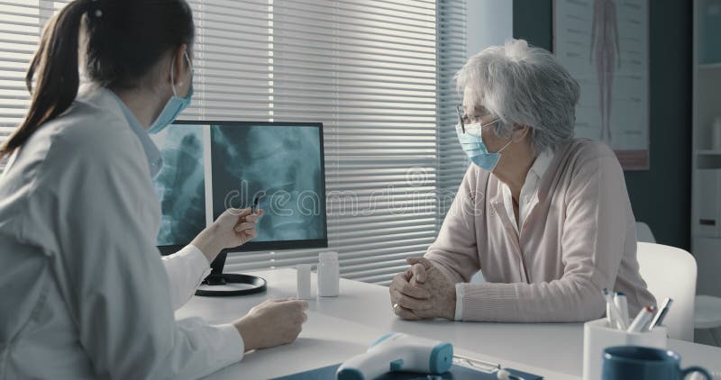 Doctor Checking an X-ray Image with a Patient Stock Image - Image of ...