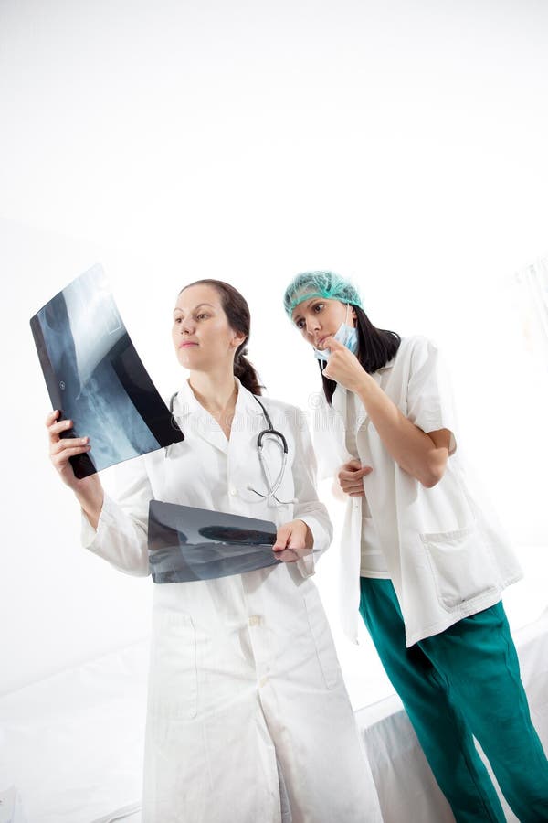 Doctor Checking X-ray Image Stock Photo - Image of brunette, magnetic ...
