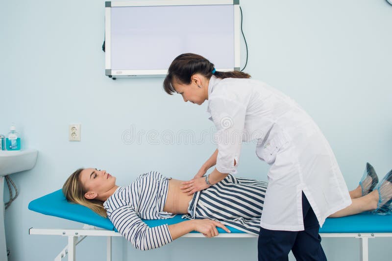 Doctor Checking the Stomach of One of Her Patients Stock Photo - Image ...
