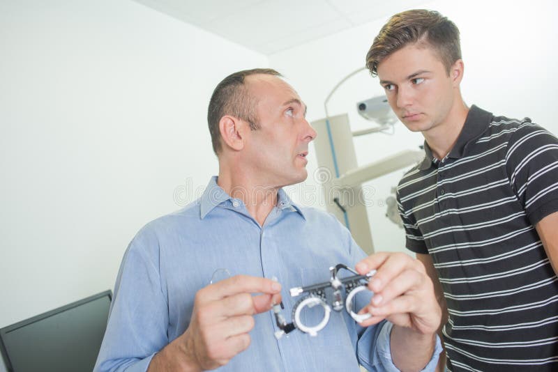 Doctor checking vision stock image. Image of ophthalmology - 302705047