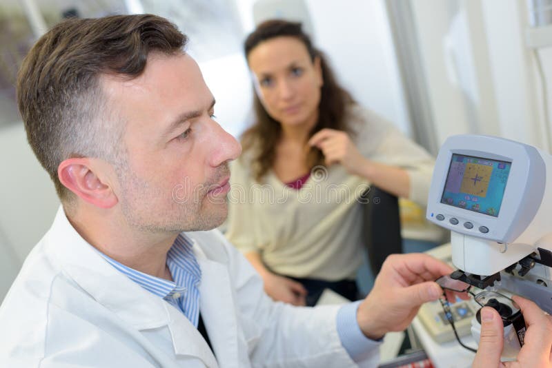 Doctor Checks Patient Eyes Using Ophthalmic Device Stock Photo - Image ...