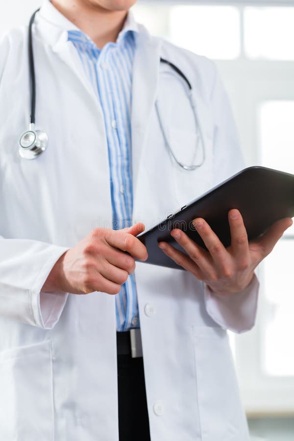 Doctor in Clinic Reading Digital File on Tablet Computer Stock Photo ...