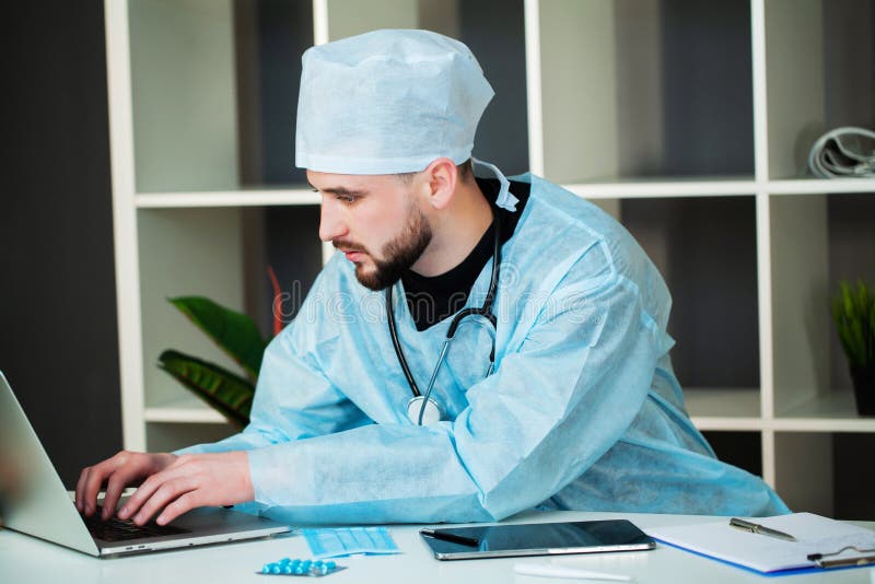 Doctor at the Clinic Works at the Computer Stock Image - Image of busy ...