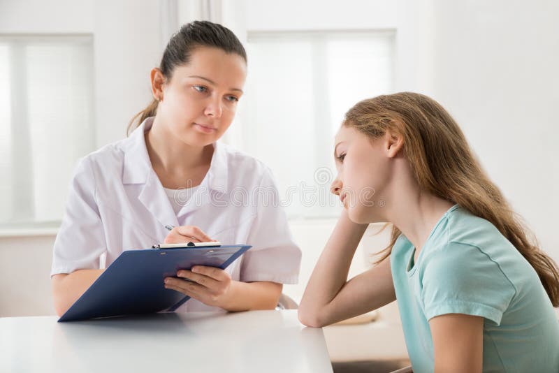 Doctor Comforting Patient at Table Stock Photo - Image of psychiatry ...