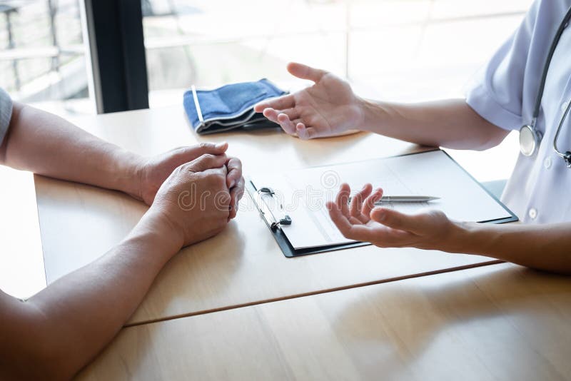Doctor Consulting with Patient Examining for Patient, Presenting ...
