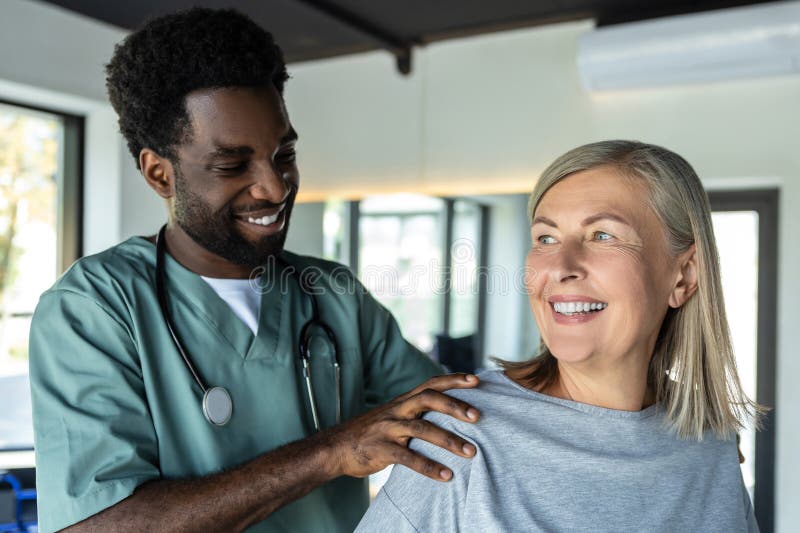 Doctor Correcting the Patients Posture and Both Looking Contented and Smiling Stock Photo ...