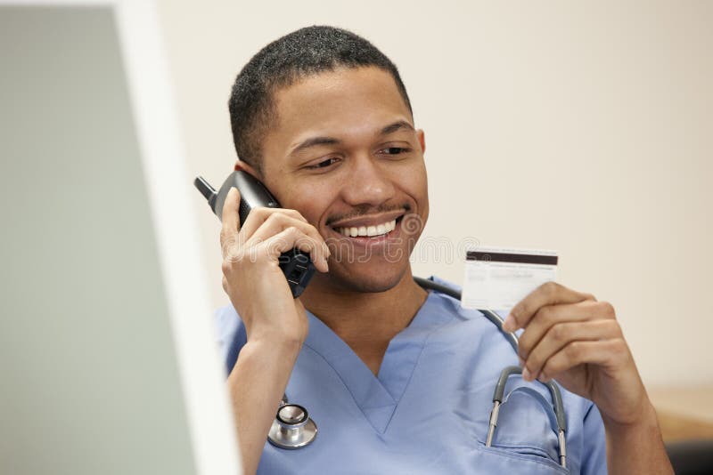 Doctor with Credit Card on Phone Stock Image - Image of male, happy ...