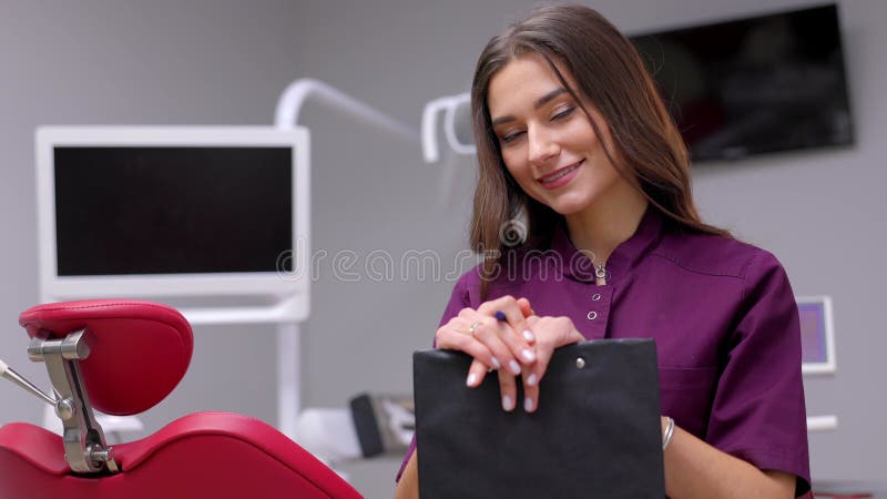 Doctor Dentist Working in Office, Using Clipboard and Making Notes ... Doctor Dentist Working in Office, Using Clipboard and Making Notes ...