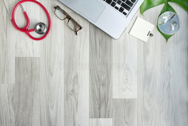 Doctor Desk Table with Stethoscope, Laptop Computer and Eyeglasses ...