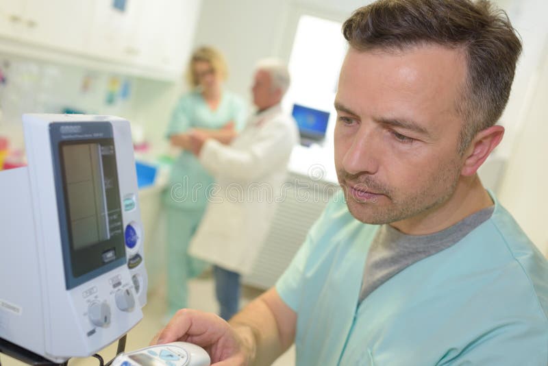 Doctor with Device Test Sitting at Table in Office Stock Image - Image ...
