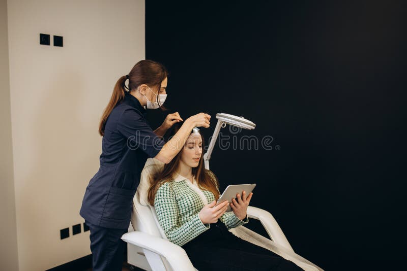 Doctor Diagnoses the Structure of the Hair. Consultation with a ...