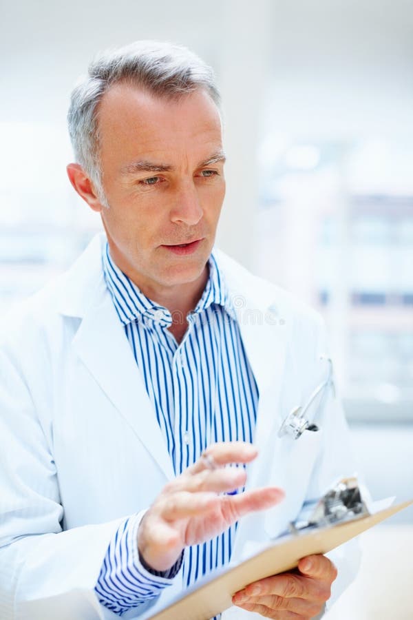 Doctor Discussing Options. Doctor Holding Clipboard while Discussing ...