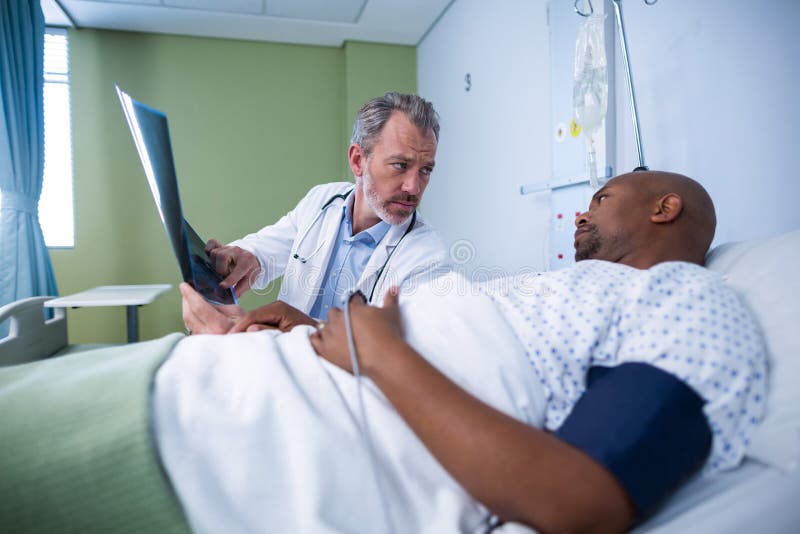 Doctor Discussing X-ray with Patient in Ward Stock Image - Image of ...