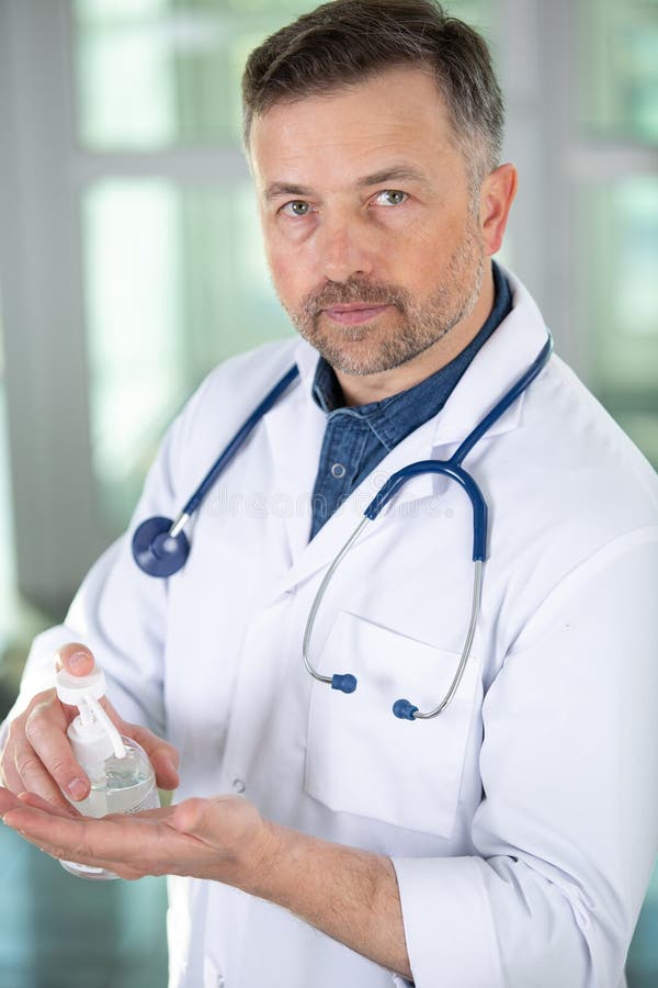 Doctor Dispensing Sanitiser into Hand Stock Image - Image of labcoat ...
