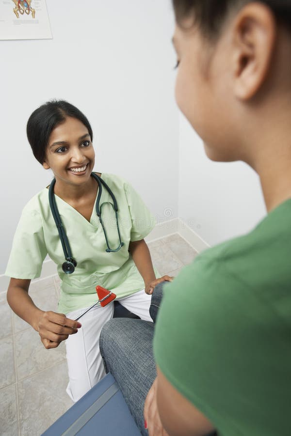 Doctor Doing Flex Test on Girl Stock Photo - Image of happy, looking ...