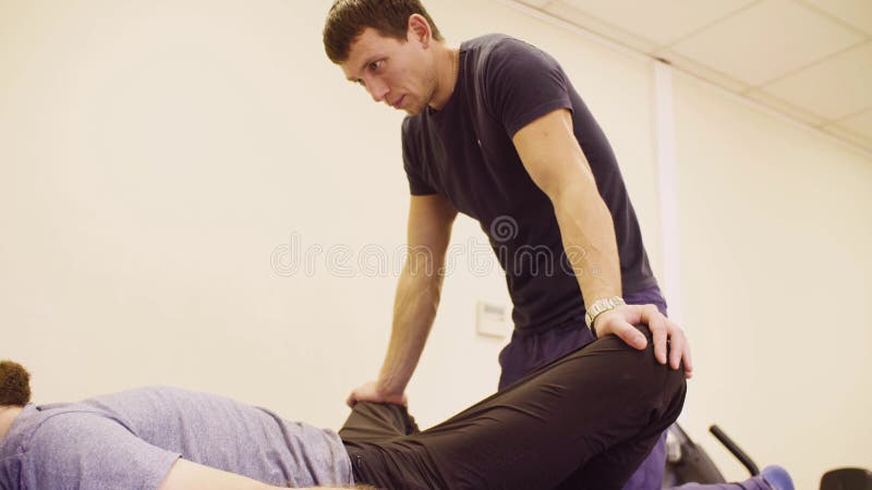 Doctor Doing Stretching Exercises for Disable Man Stock Photo - Image ...