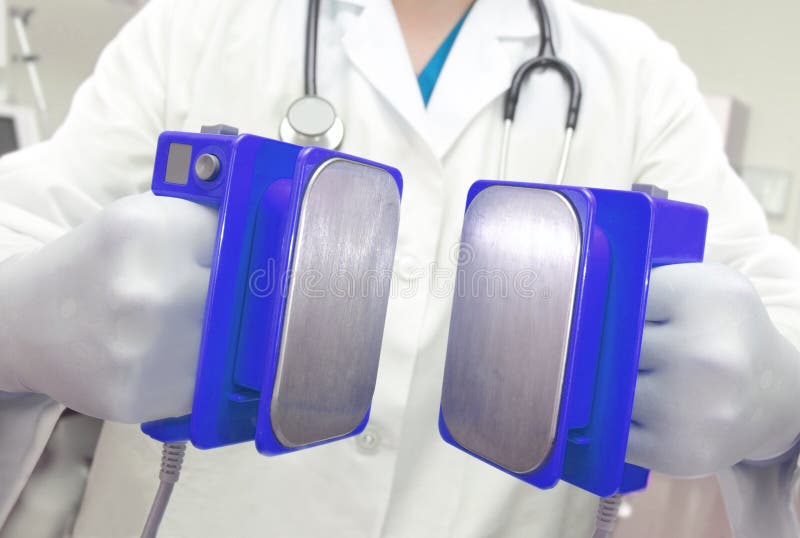 Doctor with electroshock i stock photo. Image of doctor - 31736286